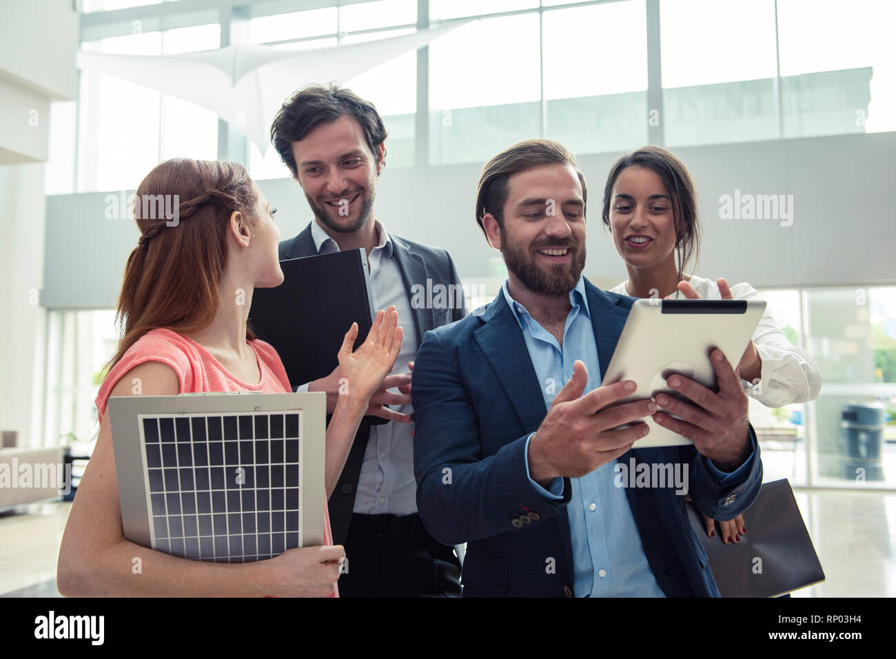 Architects discussing with each other in hotel lobby Stock Photo - Alamy