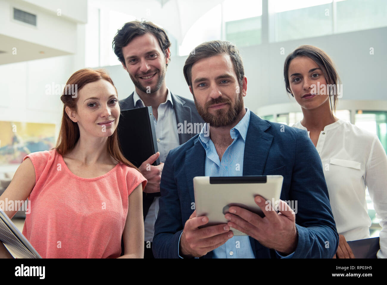 Smiling architects standing in hotel lobby Stock Photo - Alamy