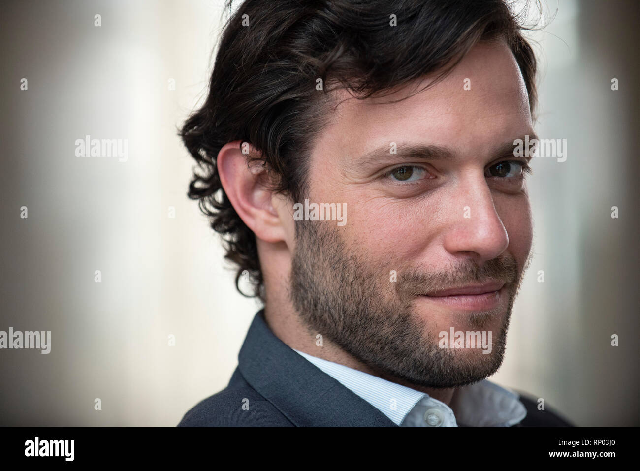 Close-up of smiling businessman in hotel lobby Stock Photo - Alamy