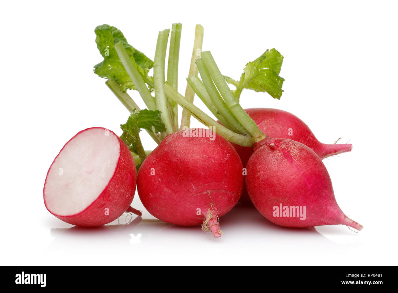 Red radish and green leaves on white background Stock Photo - Alamy