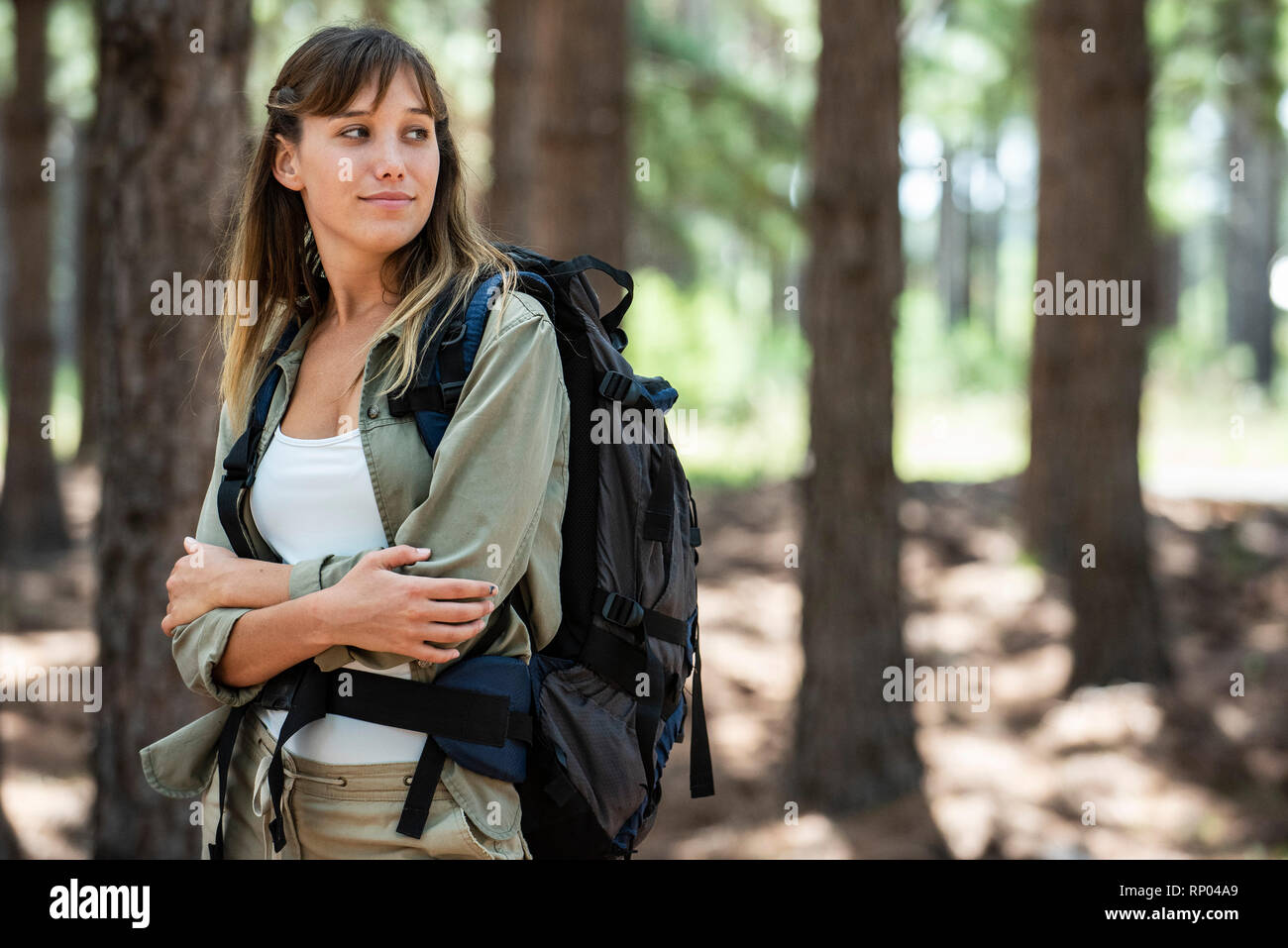 Young woman hiking in forest Stock Photo - Alamy