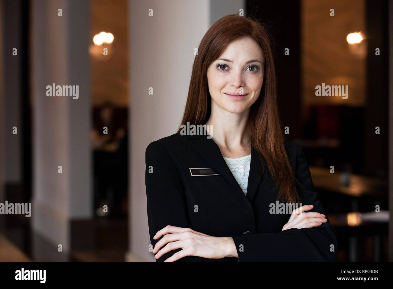 Female receptionist standing in hotel Stock Photo - Alamy
