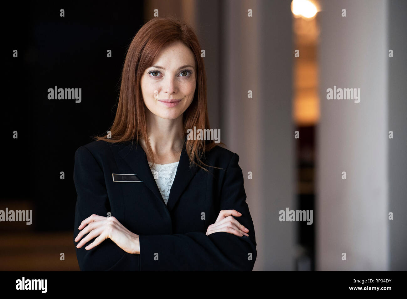 Female receptionist standing in hotel Stock Photo - Alamy
