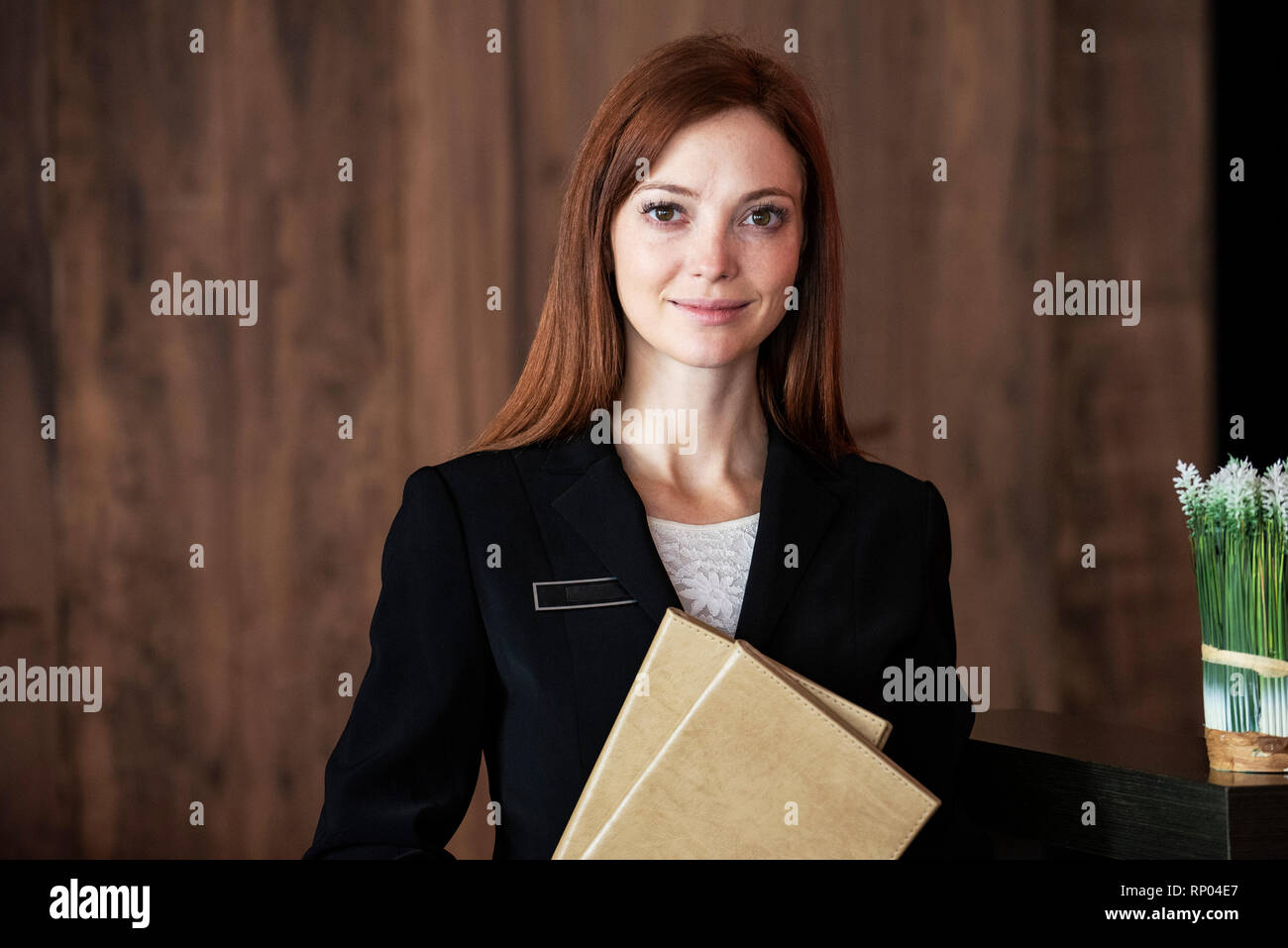 Female receptionist standing in hotel Stock Photo - Alamy