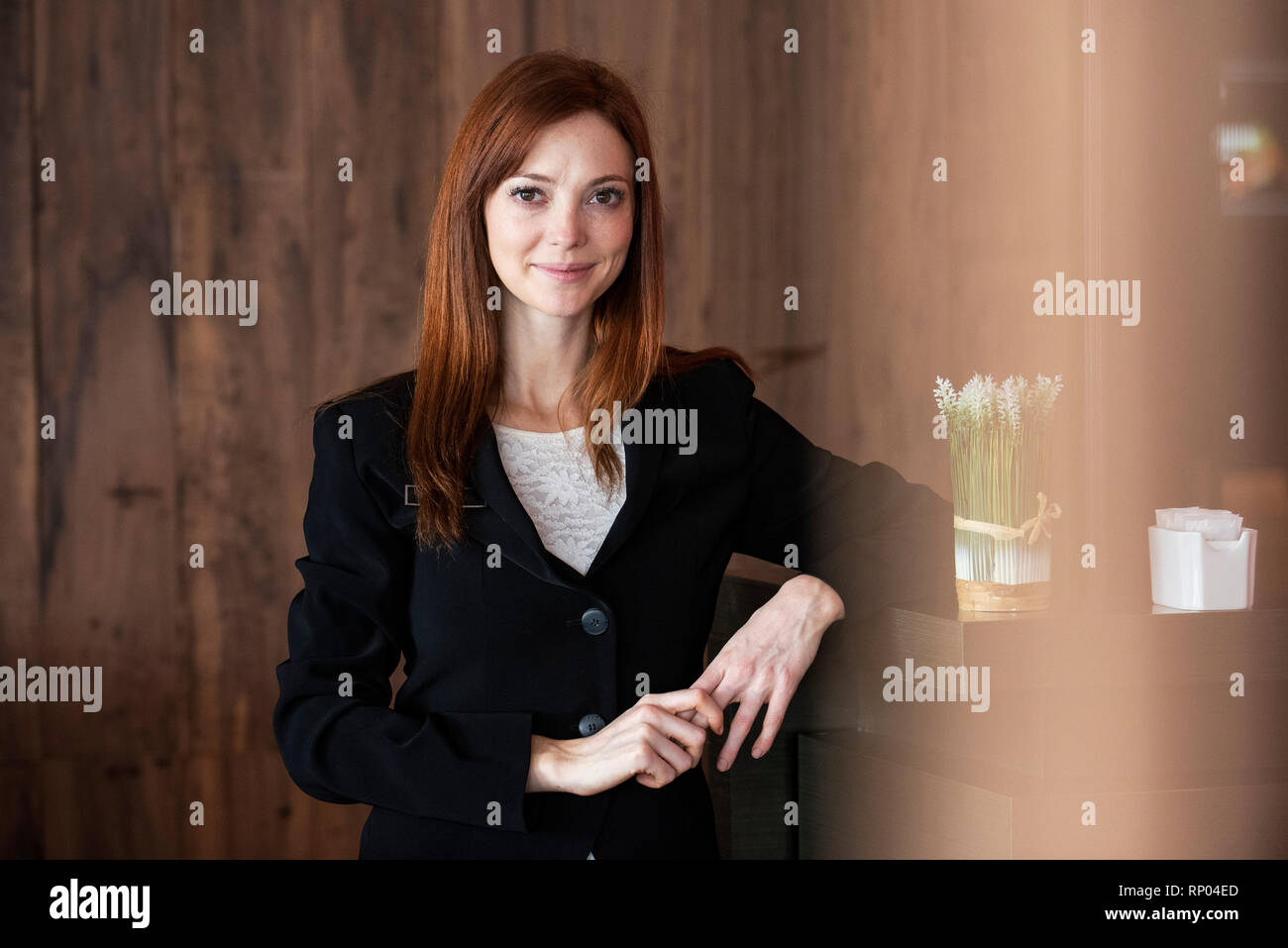 Female receptionist standing in hotel Stock Photo - Alamy