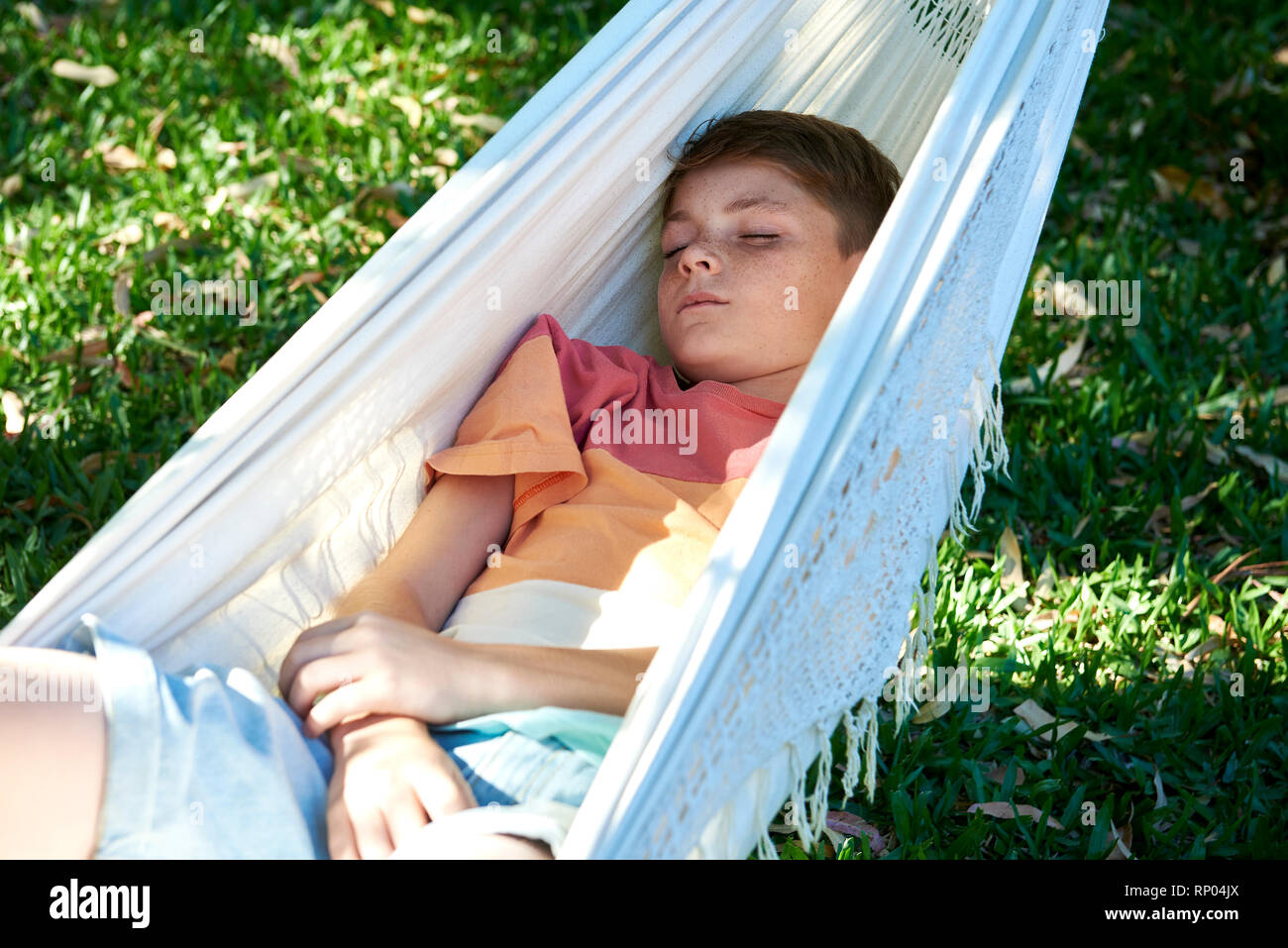 Boy relaxing in hammock Stock Photo - Alamy