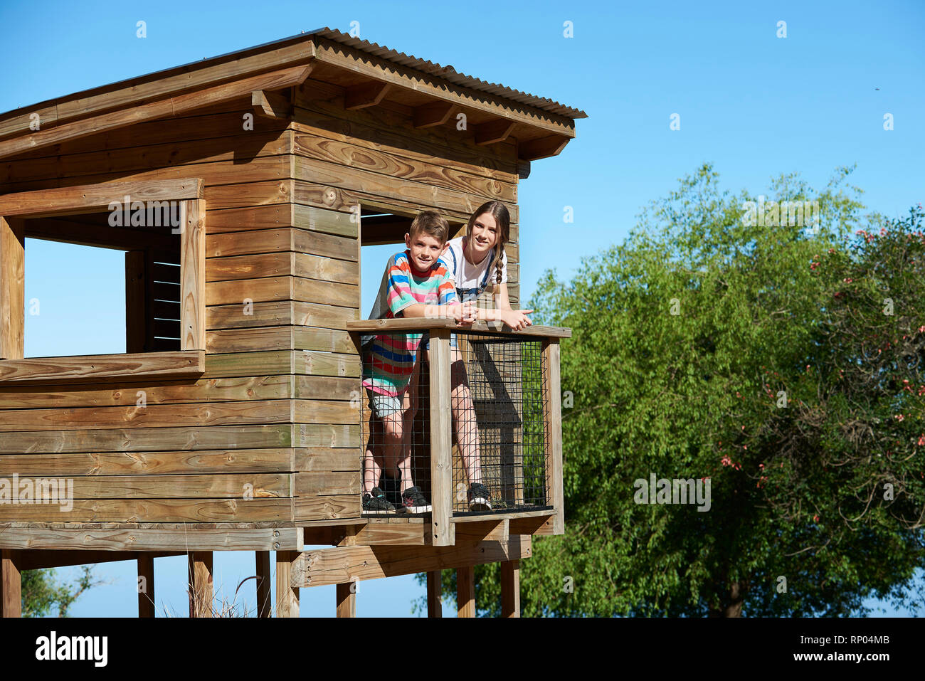 Boy and teenage girl standing in a log cabin Stock Photo - Alamy