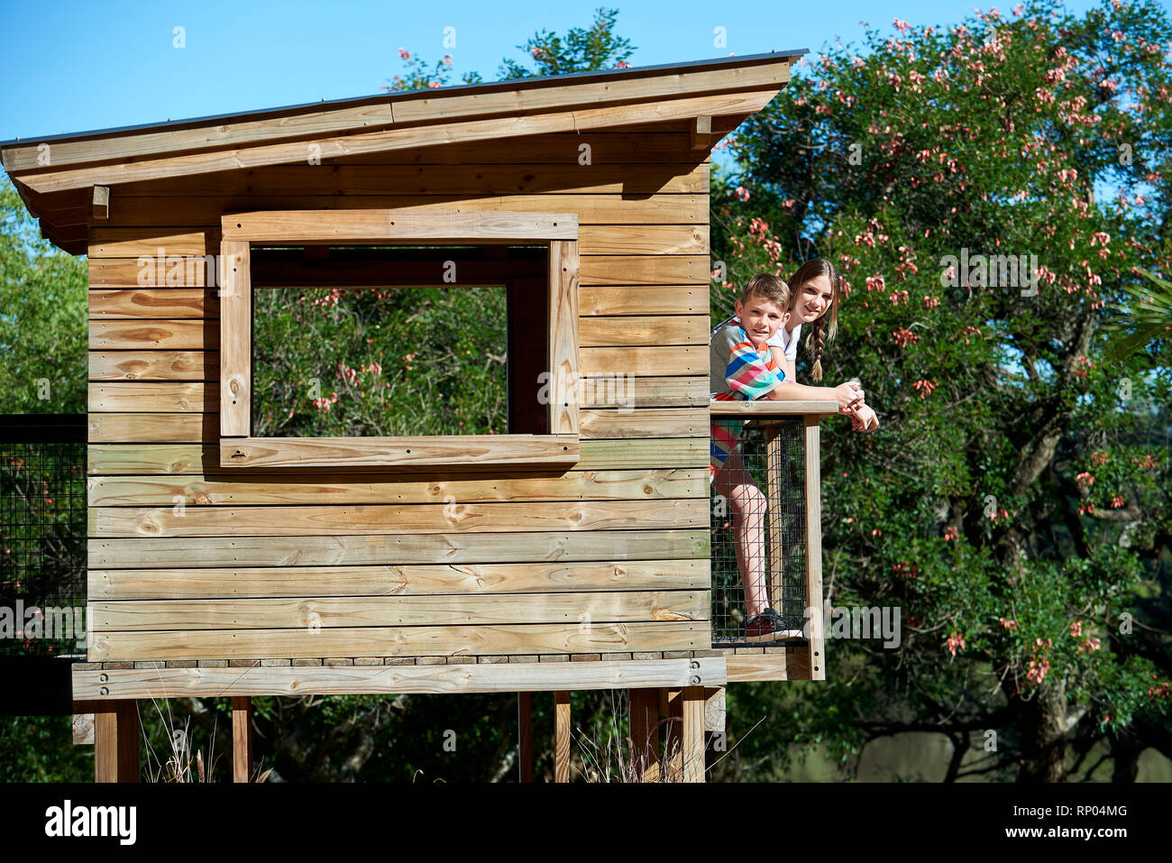 Boy and teenage girl standing in a log cabin Stock Photo - Alamy