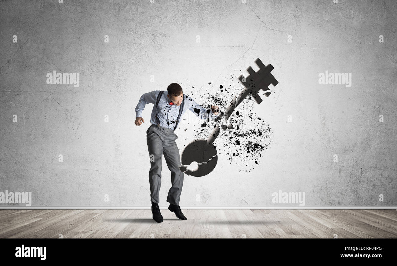 Breaking through access concept with man in room crashing concrete key ...