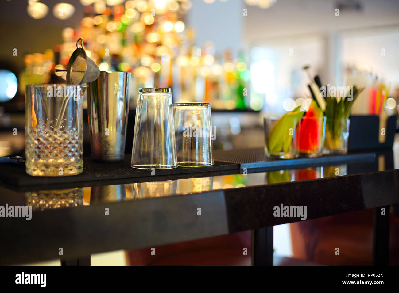 Classic bar counter with bottles in blurred background Stock Photo - Alamy