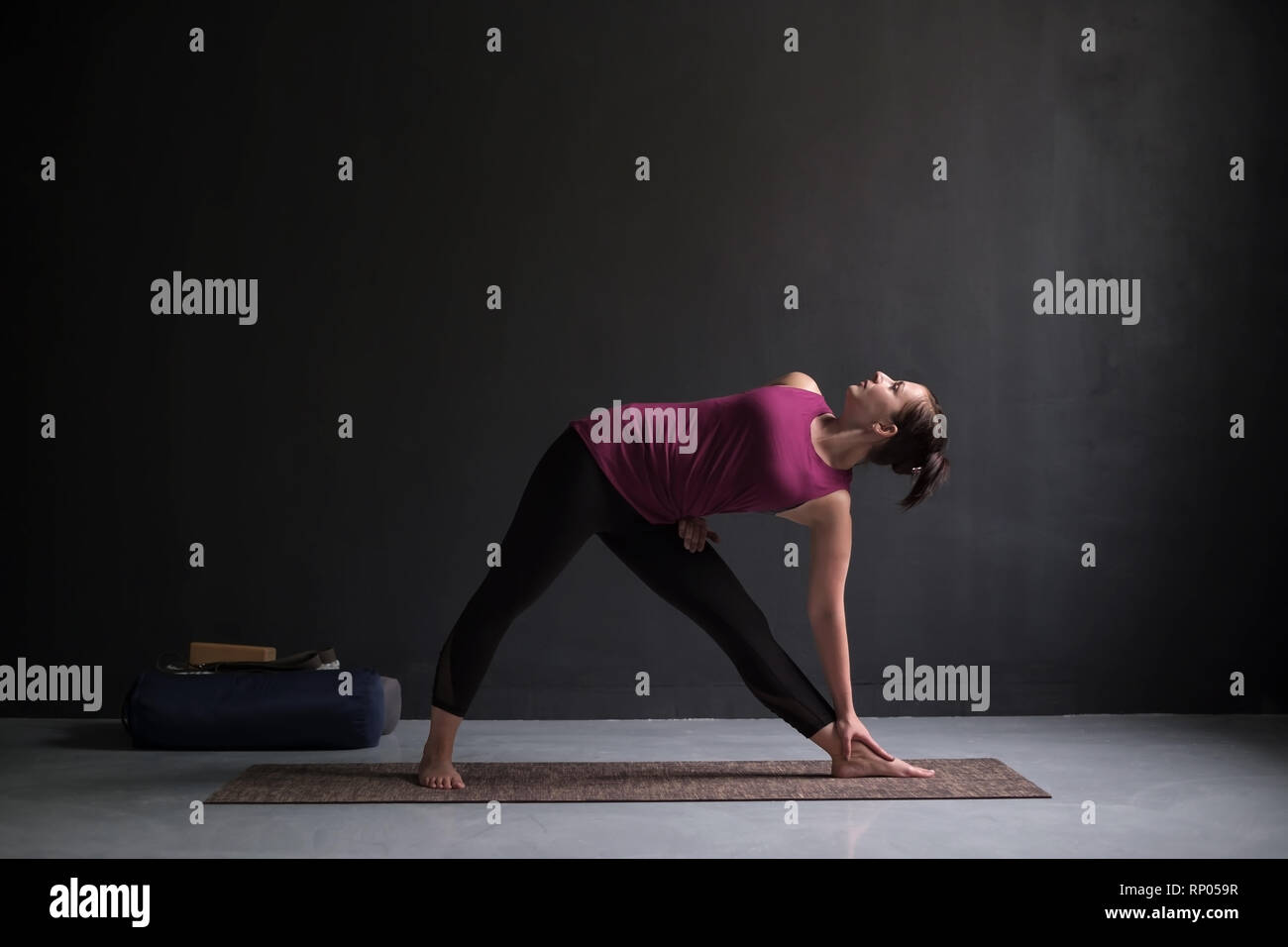 Girl standing in Utthita Trikonasana, extended triangle pose Stock ...