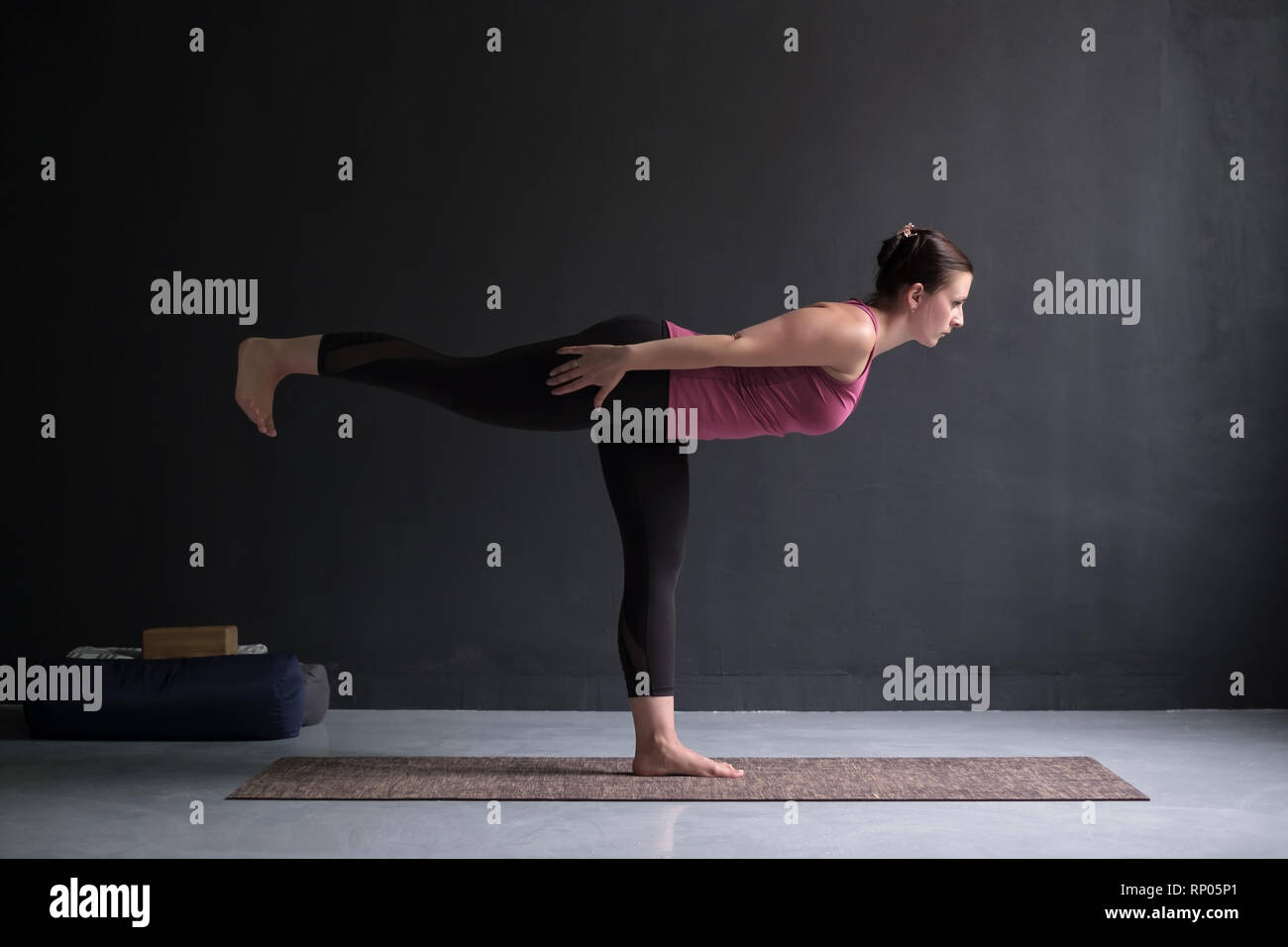 woman practicing yoga, doing Warrior III exercise, Virabhadrasana 3 ...