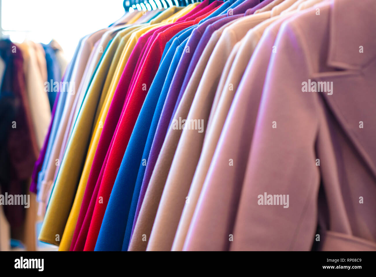 Multi-colored coat on a hanger in a clothing store Background Stock ...
