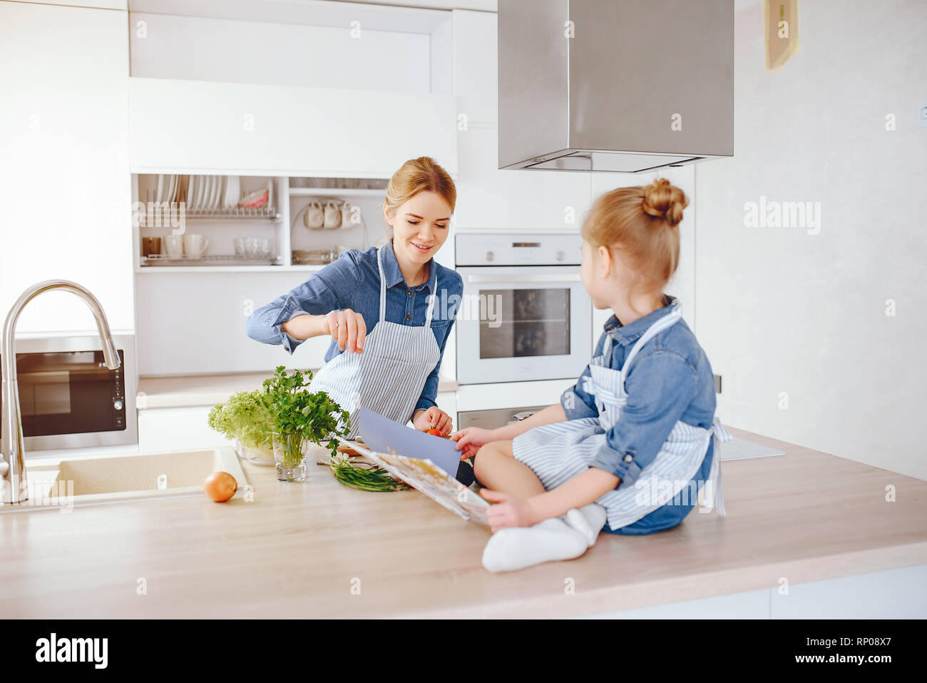 mother with daughter in the kitchen Stock Photo - Alamy