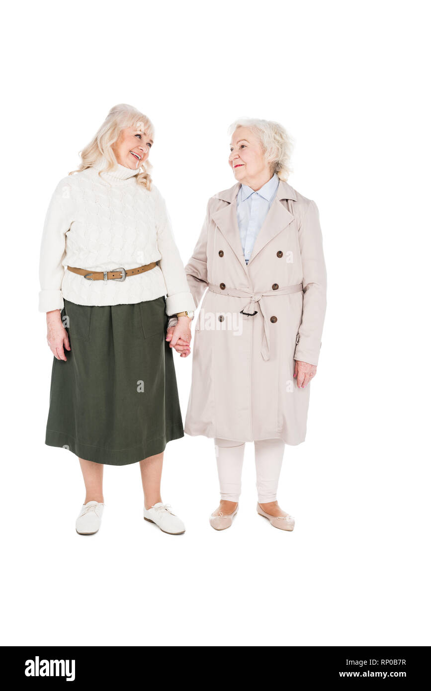 happy retired women holding hands isolated on white Stock Photo - Alamy