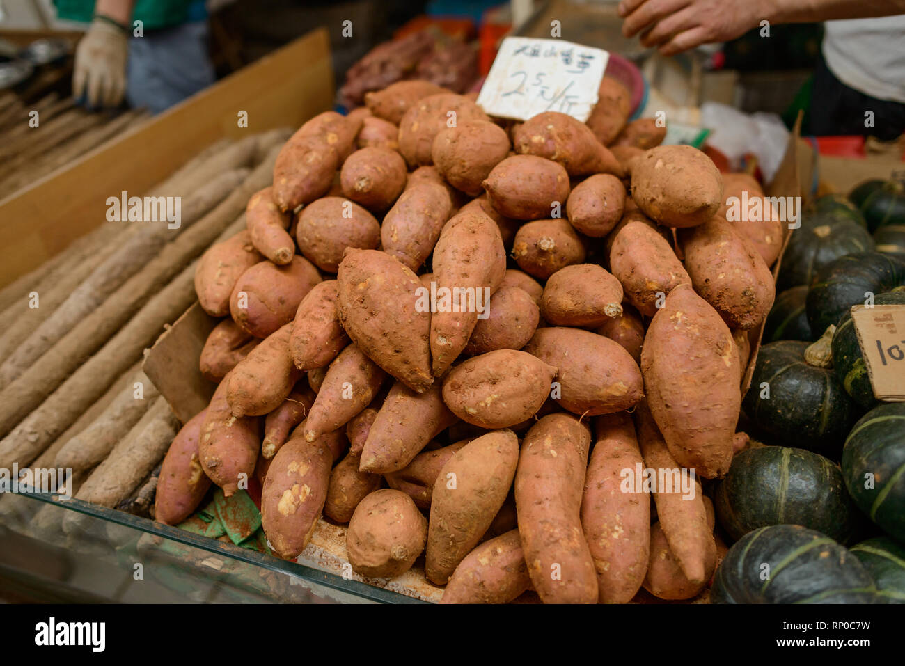 Sweet potato at a market Stock Photo - Alamy