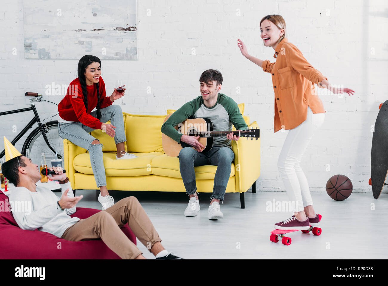 multicultural friends having fun at home in spacious living room Stock ...