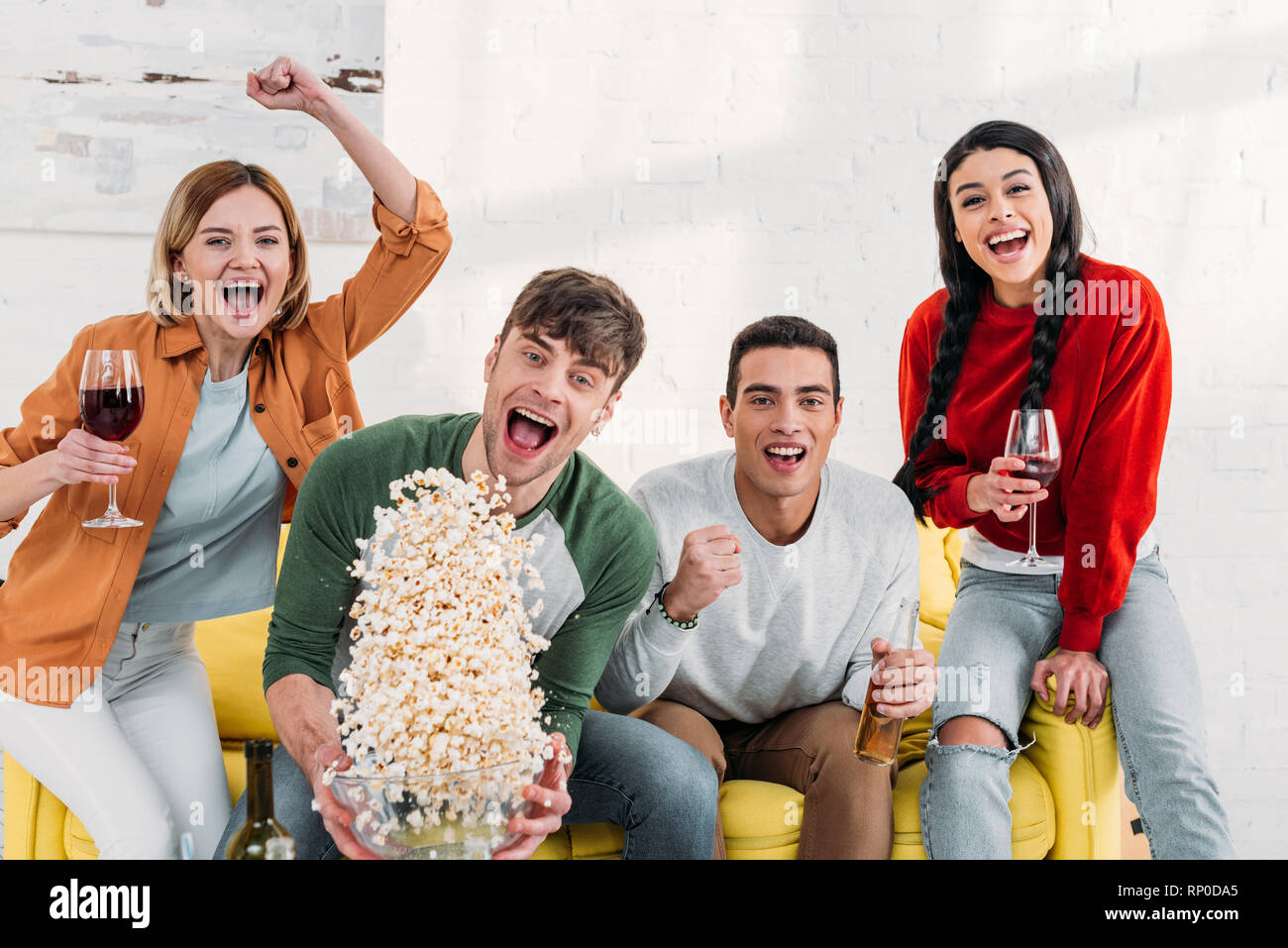 laughing multicultural friends fooling around at home party Stock Photo ...