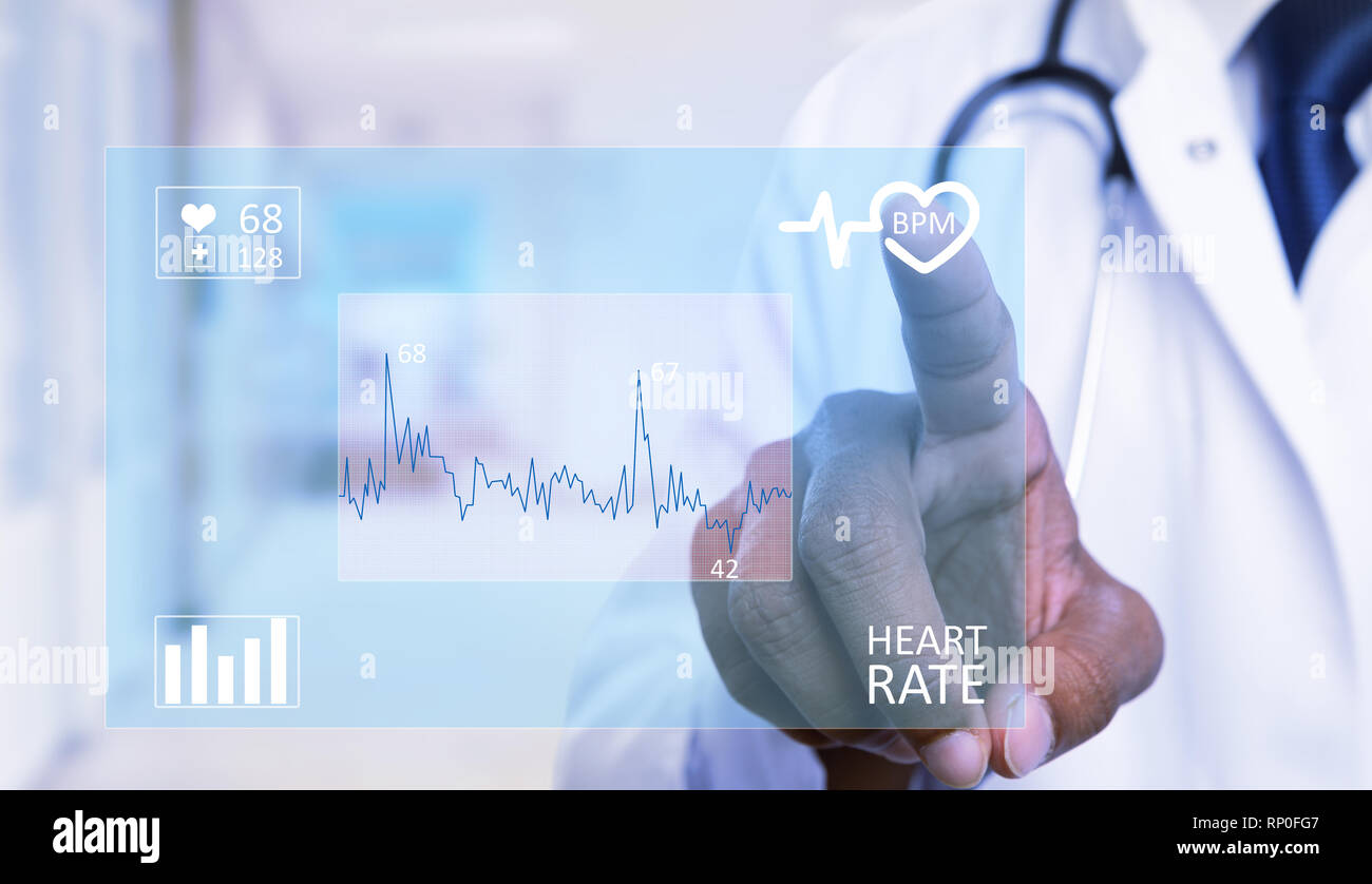 Close-up indian male cardiology medic touching heart symbol on ...