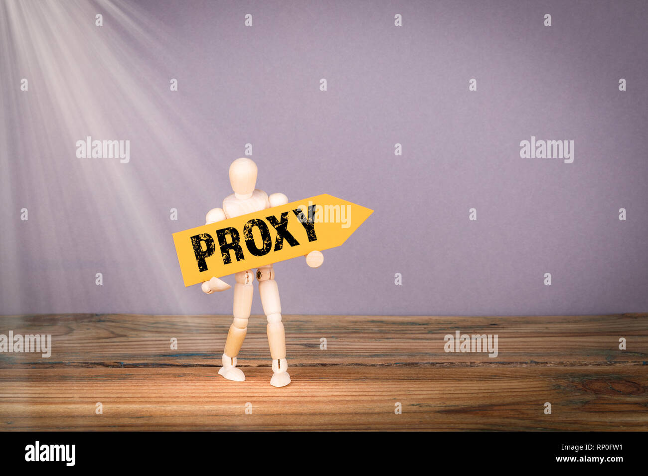 Proxy concept. Wooden man with yellow an arrow Stock Photo - Alamy