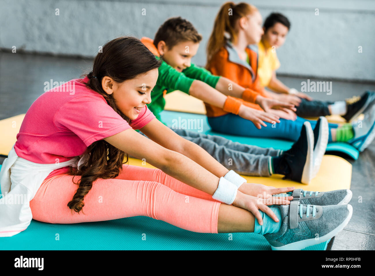 Group of kids stretching in gym together Stock Photo - Alamy