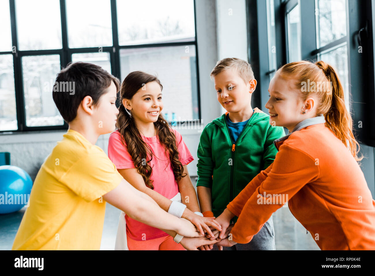 Group of happy kids holding hands in gym Stock Photo - Alamy