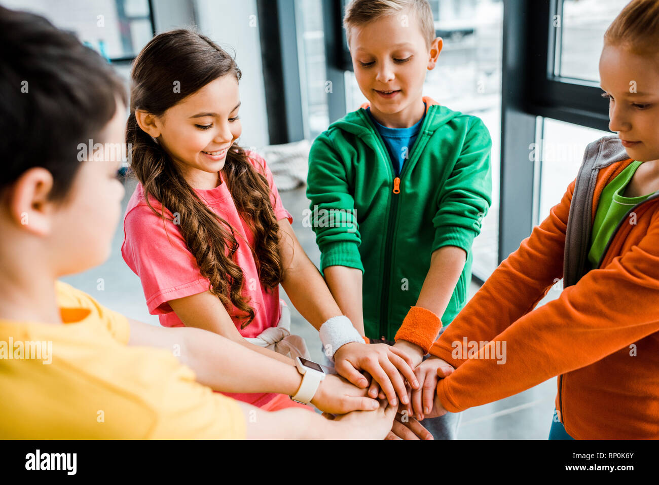 Group of kids preparing for sport competition and holding hands Stock ...