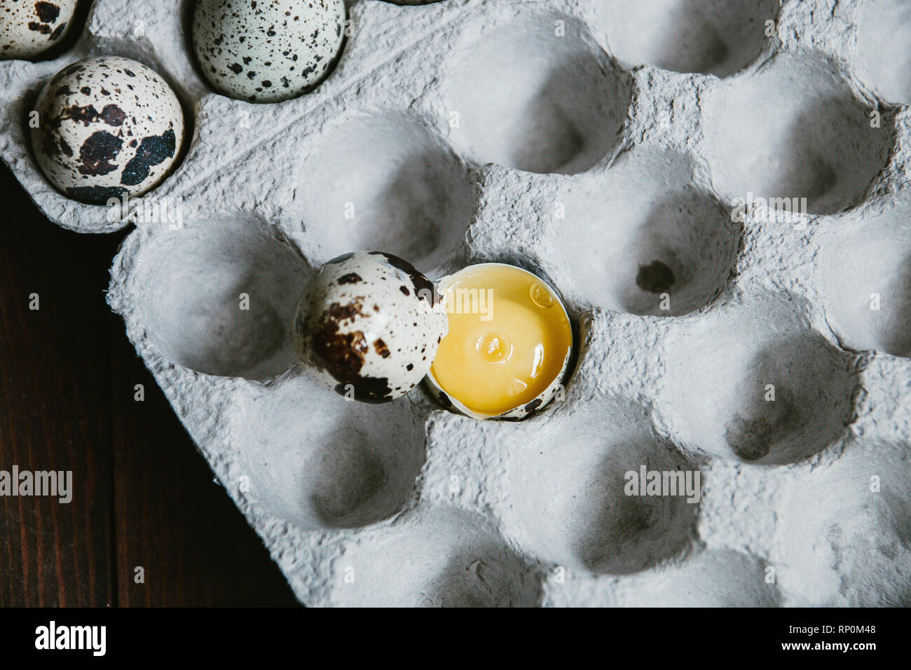 Quail eggs in cardboard packaging. Yolk of quail eggs without shell ...