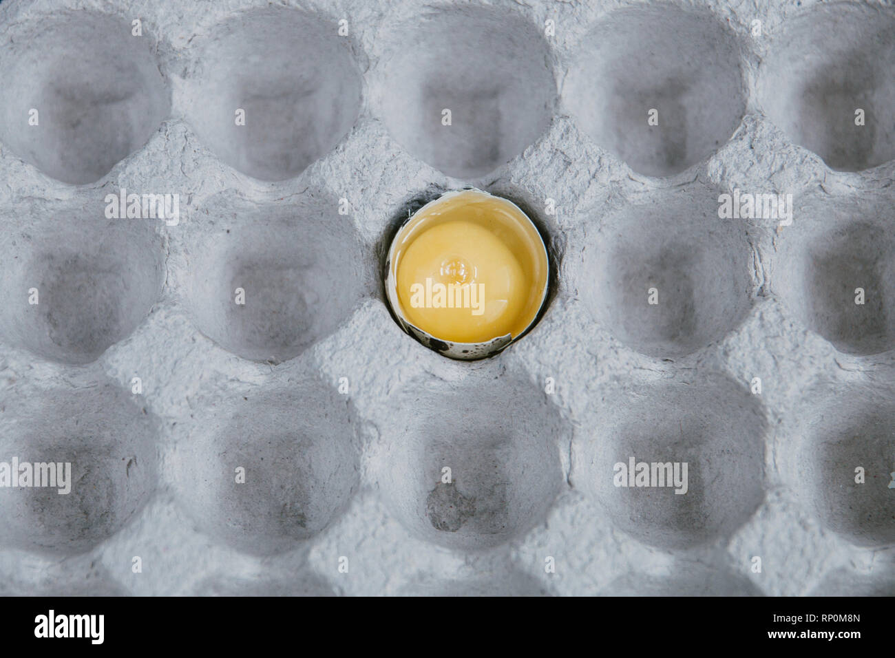 Quail eggs in cardboard packaging. Yolk of quail eggs without shell ...