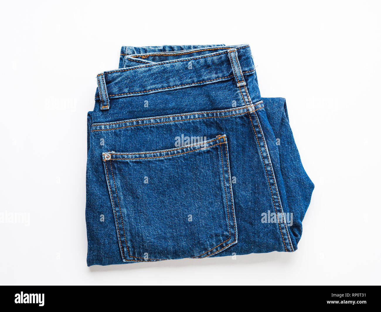 Pair of blue denim jeans folded on white background Stock Photo - Alamy