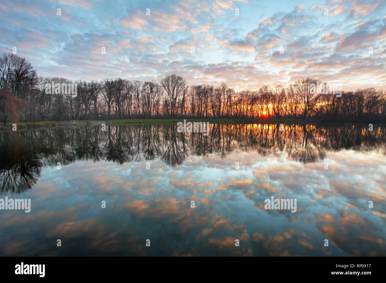 Lake sunset over forest Stock Photo - Alamy