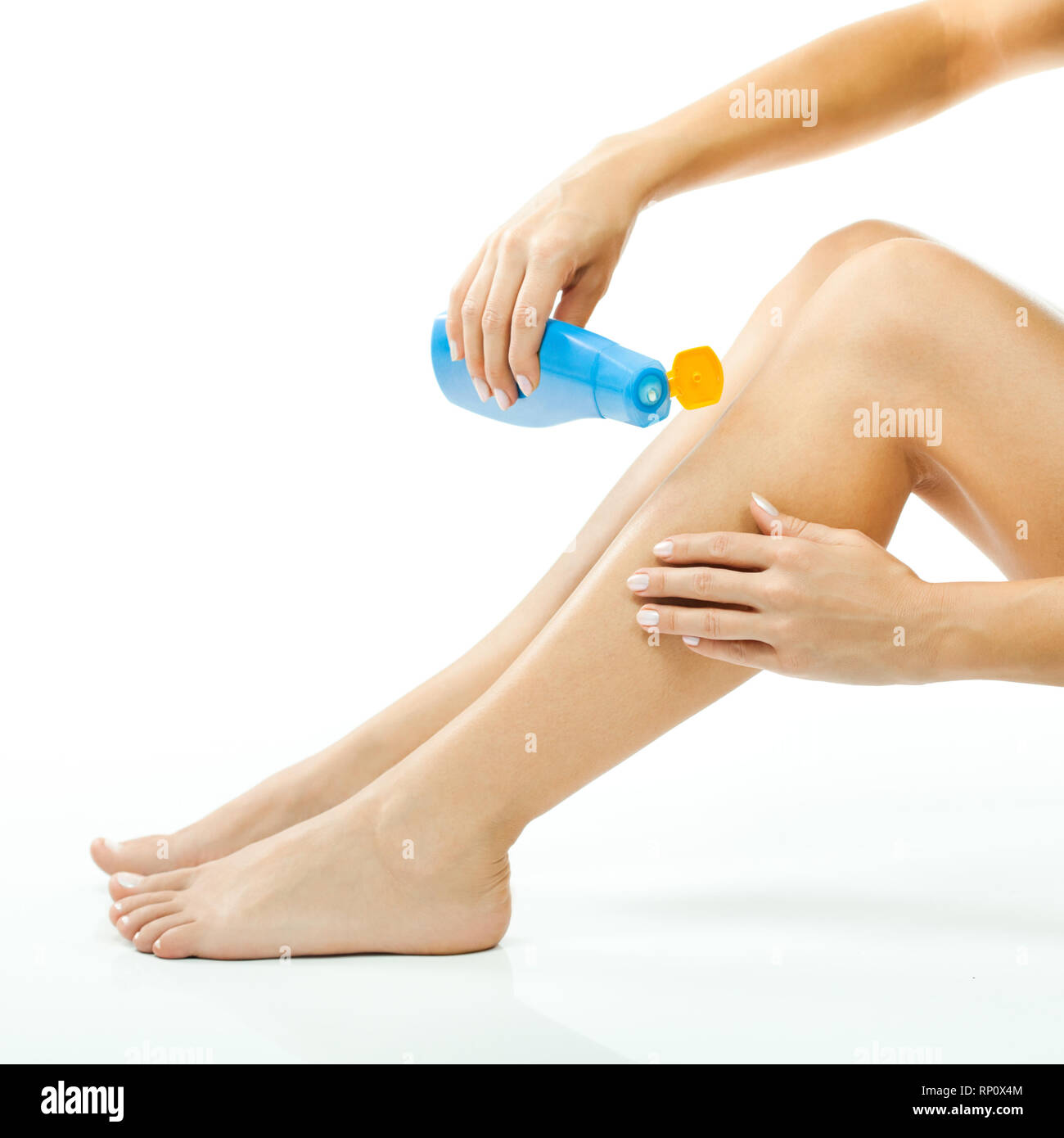 Young woman applying skin cream on her body Stock Photo - Alamy