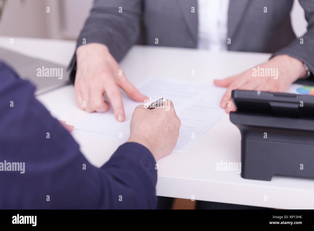 Two women at the office. Concept for signing a contract Stock Photo - Alamy