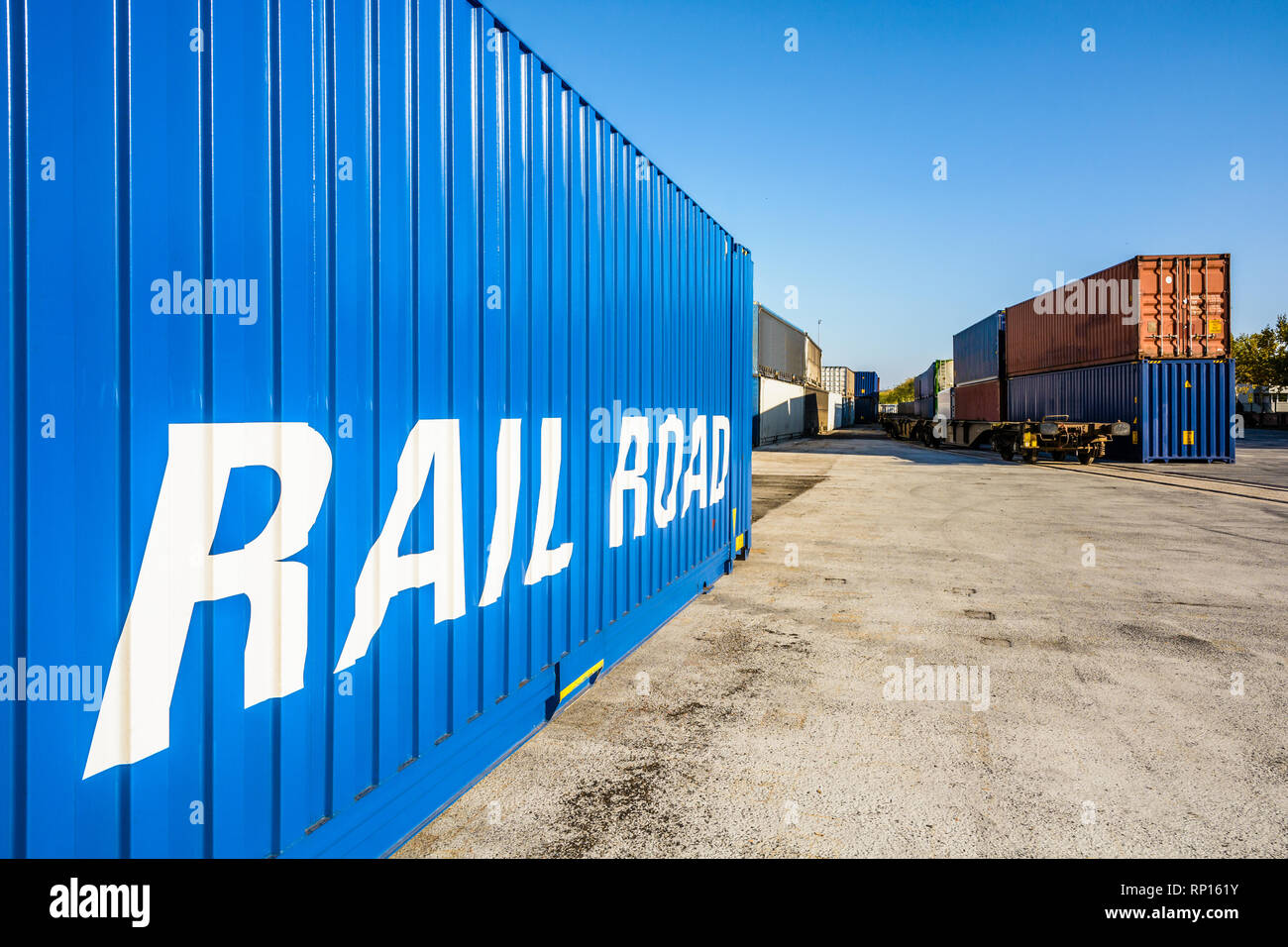 Shipping containers waiting on a railroad platform along a freight ...