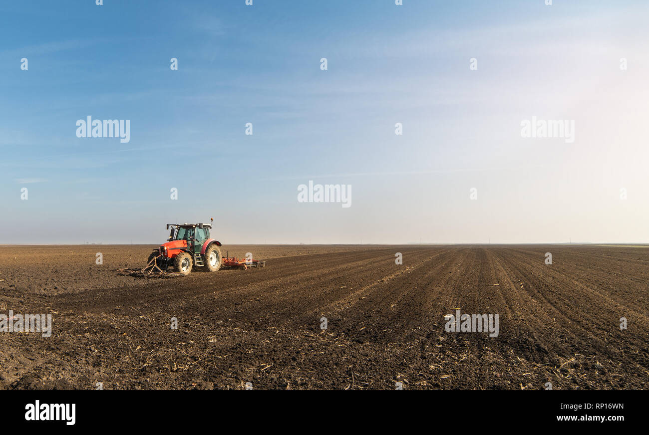 Tractors plowing stubble fields Stock Photo - Alamy