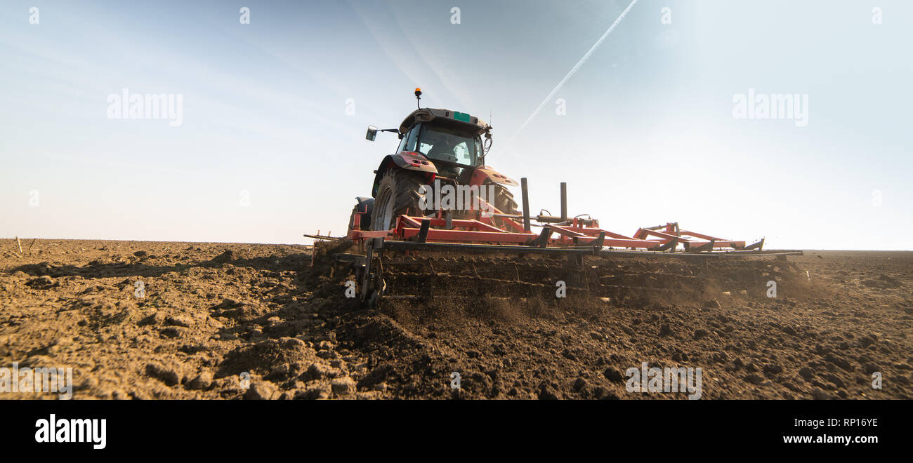 Tractors plowing stubble fields Stock Photo - Alamy