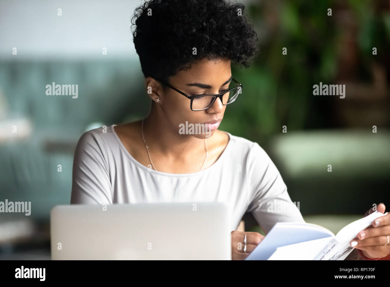 Concentrated african beautiful woman studying reading a book Stock ...