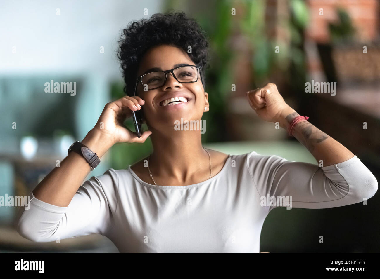 Happy african rewarded businesswoman laughing with joy Stock Photo - Alamy