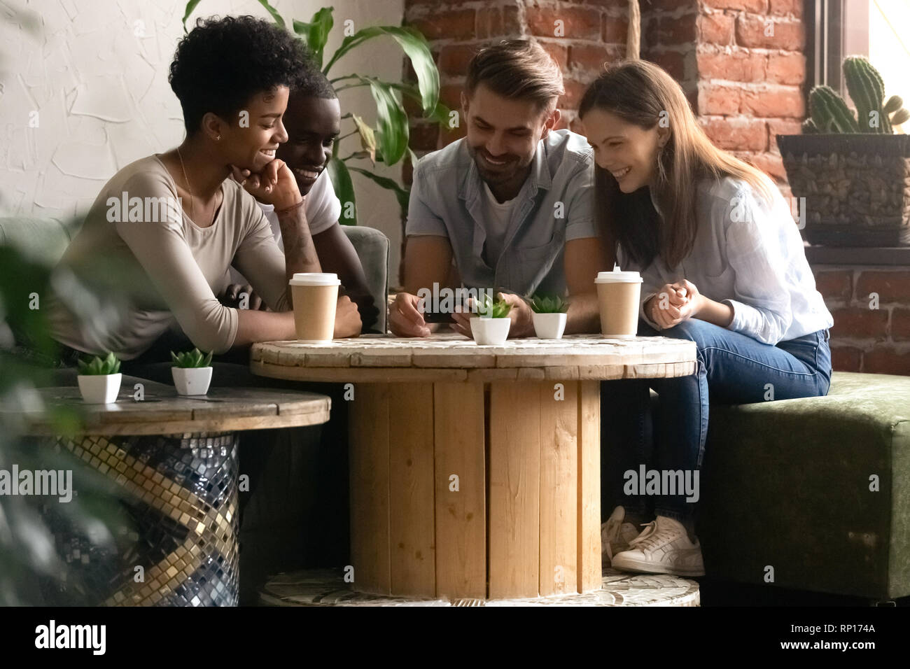 Diverse friends spending free time together in coffee house Stock Photo ...