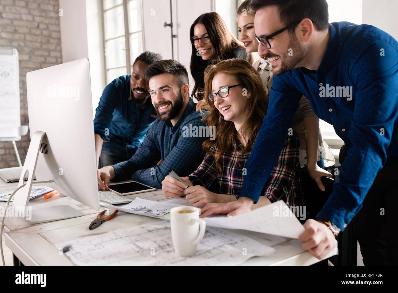 Picture of architects working together in office Stock Photo - Alamy