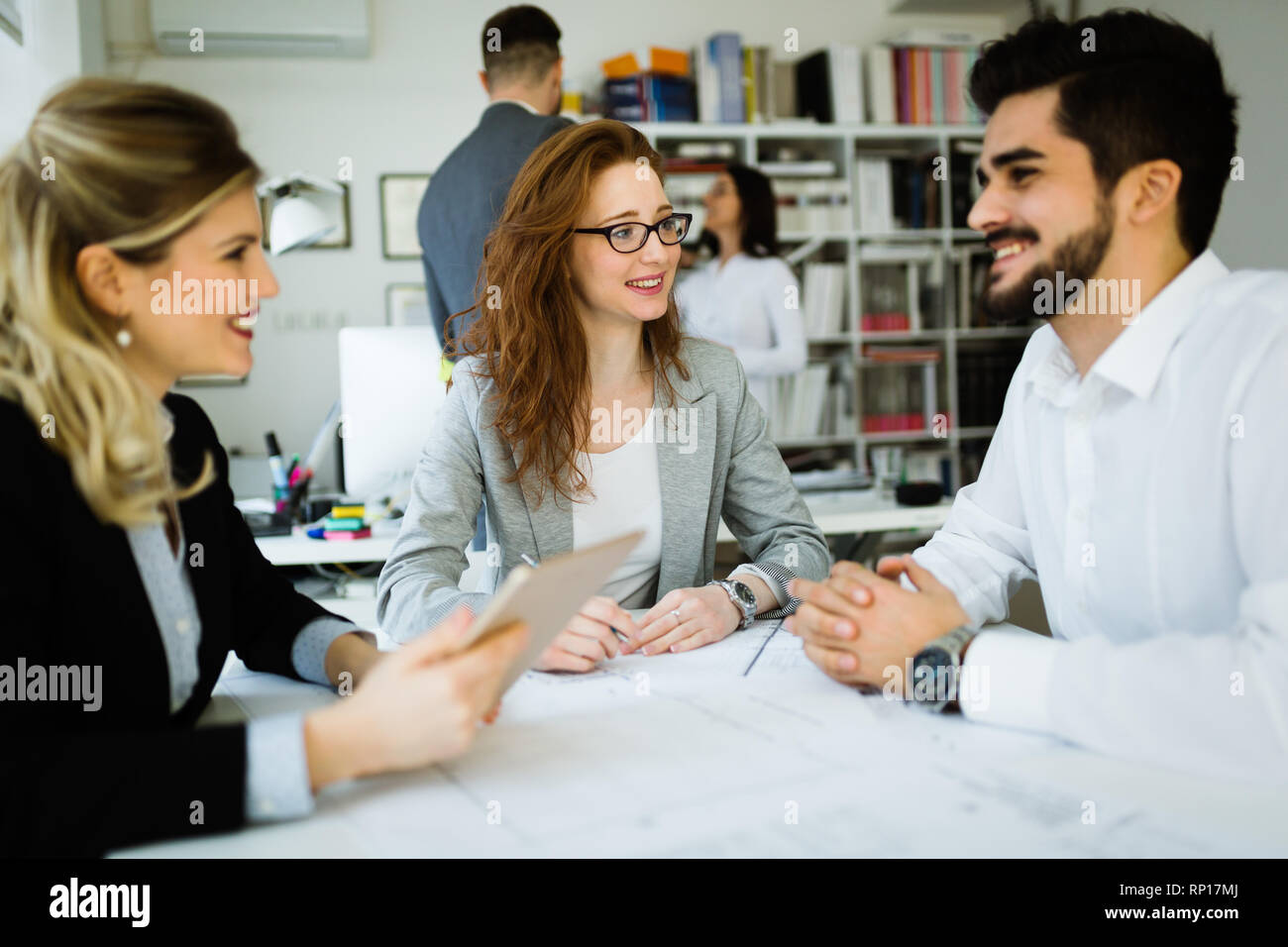 Happy colleagues casual chat at the office Stock Photo - Alamy