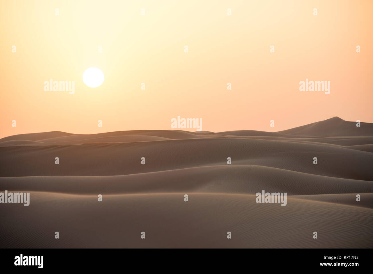 Warm desert sunset with clears orange sky Stock Photo - Alamy
