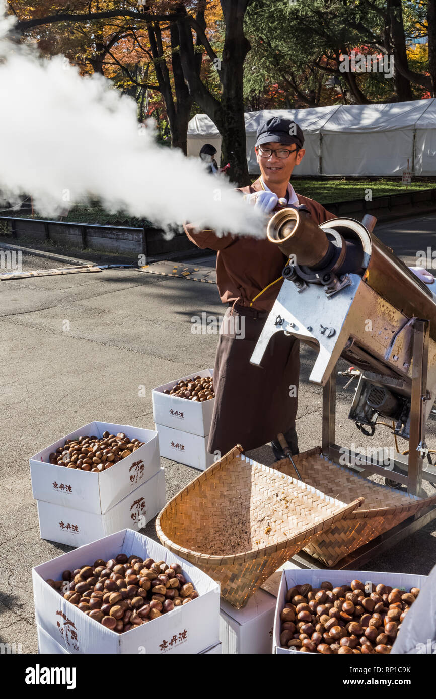 Japan, Honshu, Tokyo, Hibiya Park, Food Festival, Man Making Roasted ...