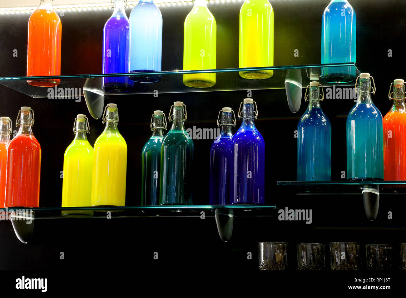 colored glass bottles in the bar shelf without labels Stock Photo - Alamy