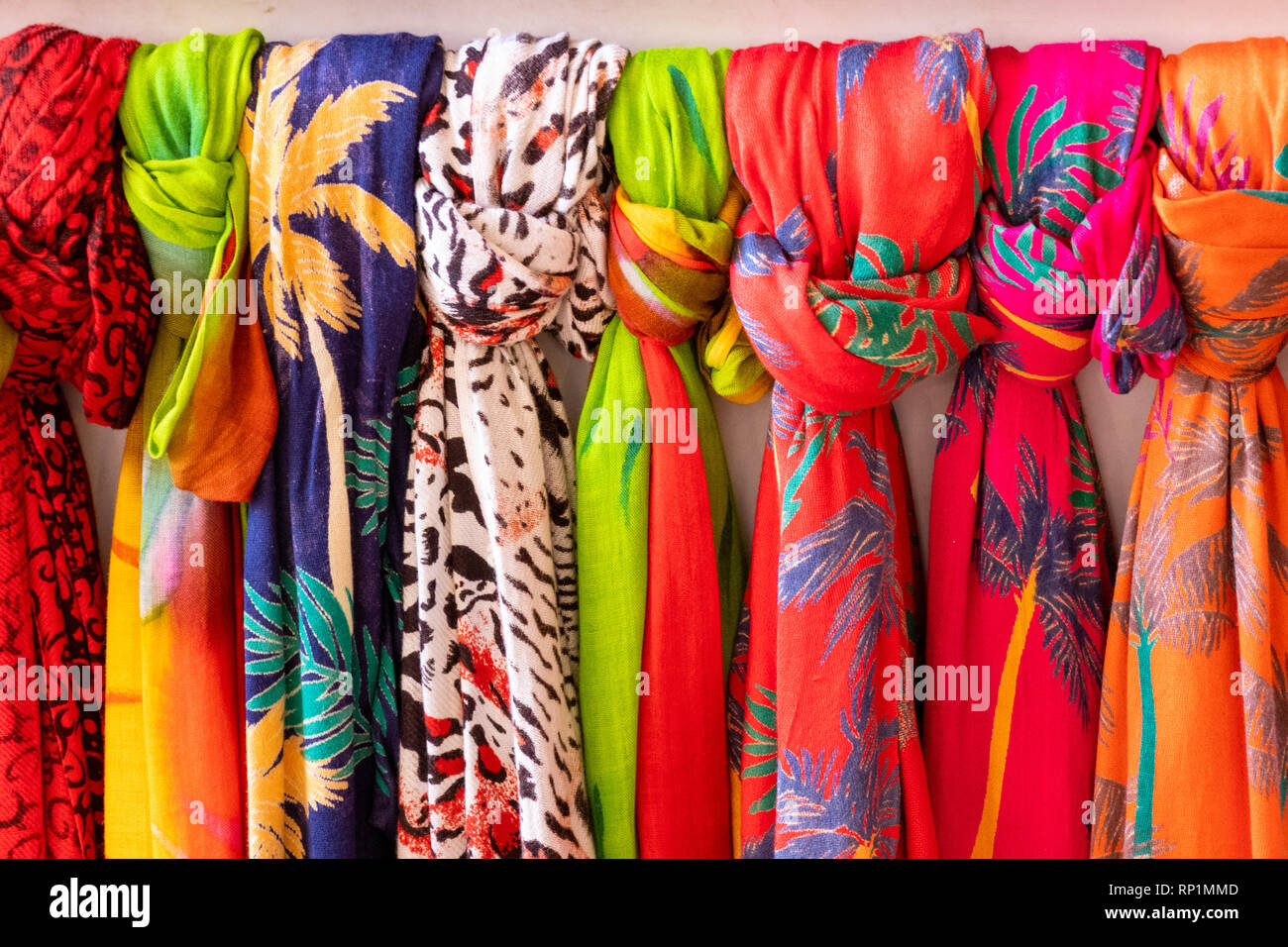 Colorful fabric hanging in stall Stock Photo - Alamy
