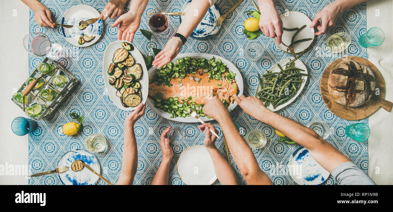 Mediterranean style dinner. Flat-lay of table with cooked salmon ...