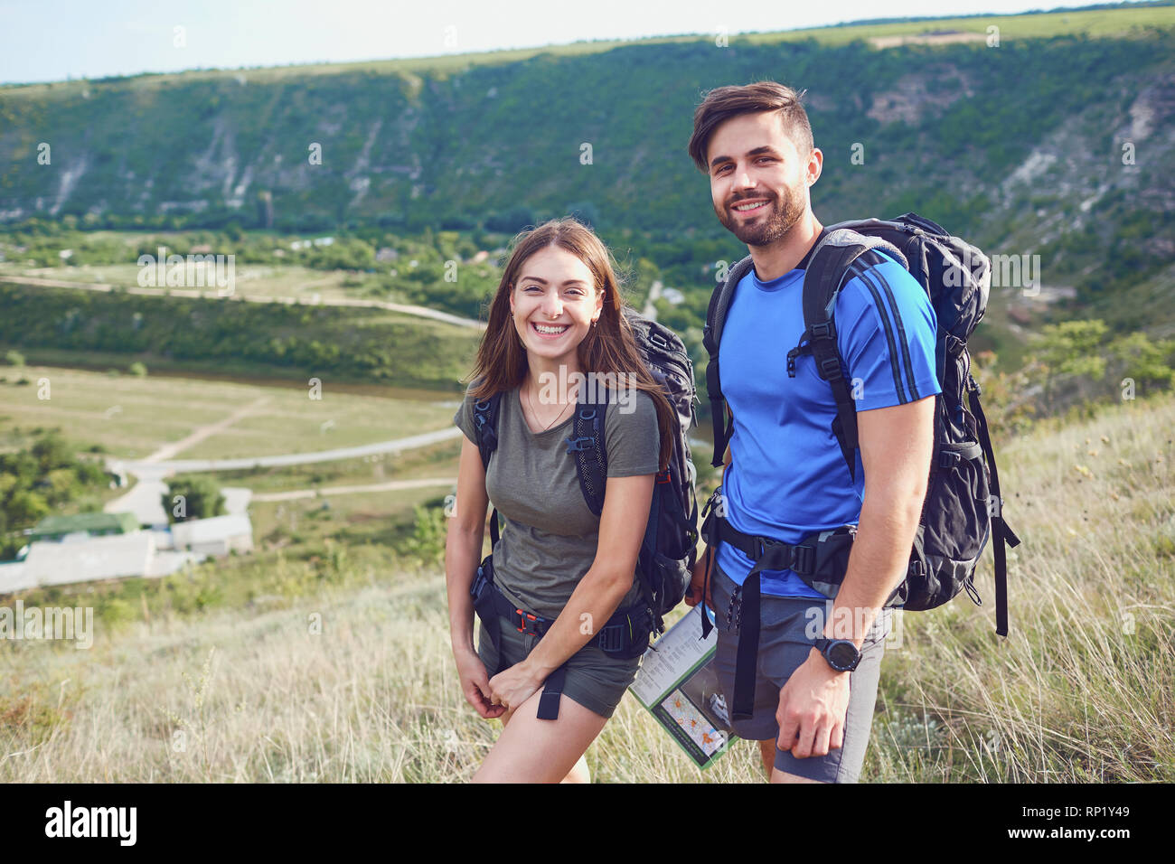 Happy couple of tourists smiling in nature Stock Photo - Alamy