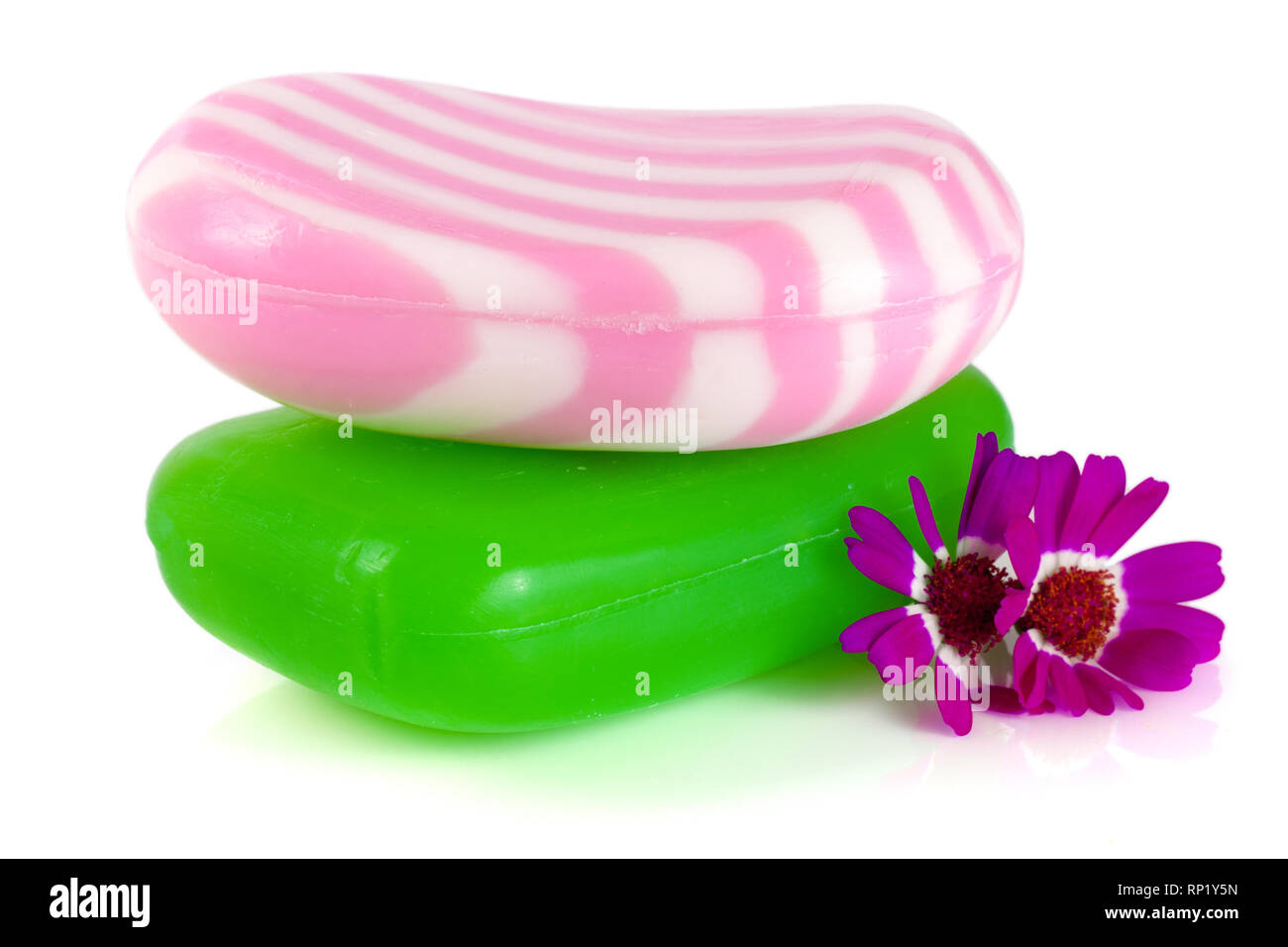 Two multi-colored striped soaps with a flower isolated on white ...