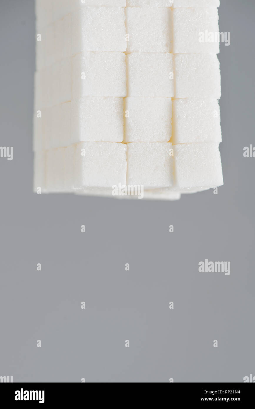 a pile of white sugar cubes, disposed in a block, upside down, on an ...