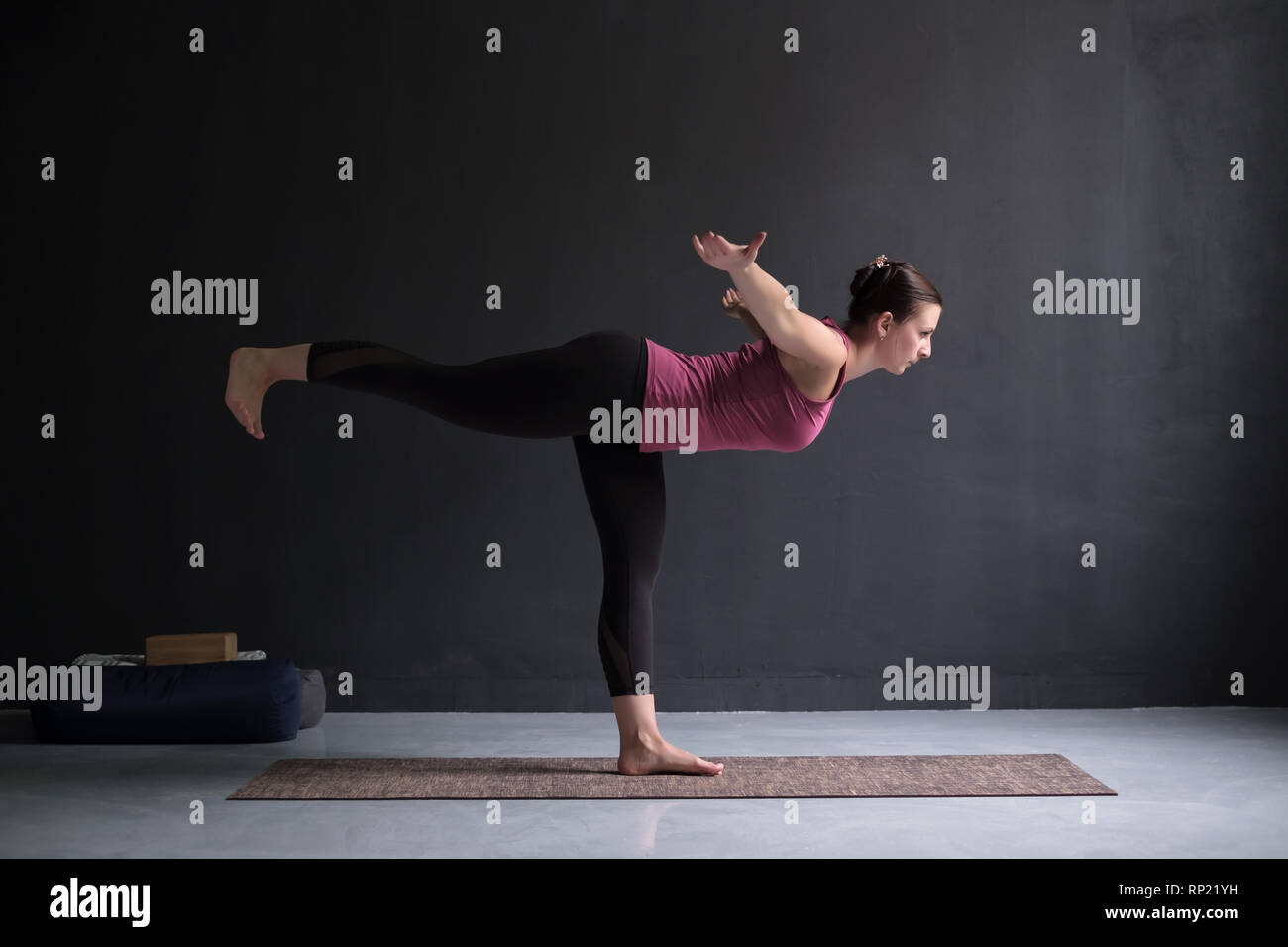 woman practicing yoga, doing Warrior III exercise, Virabhadrasana 3 ...